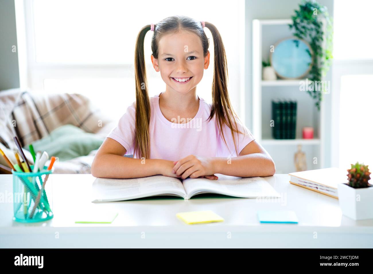 Photo of cheerful adorable clever schoolkid toothy smile opened book ...