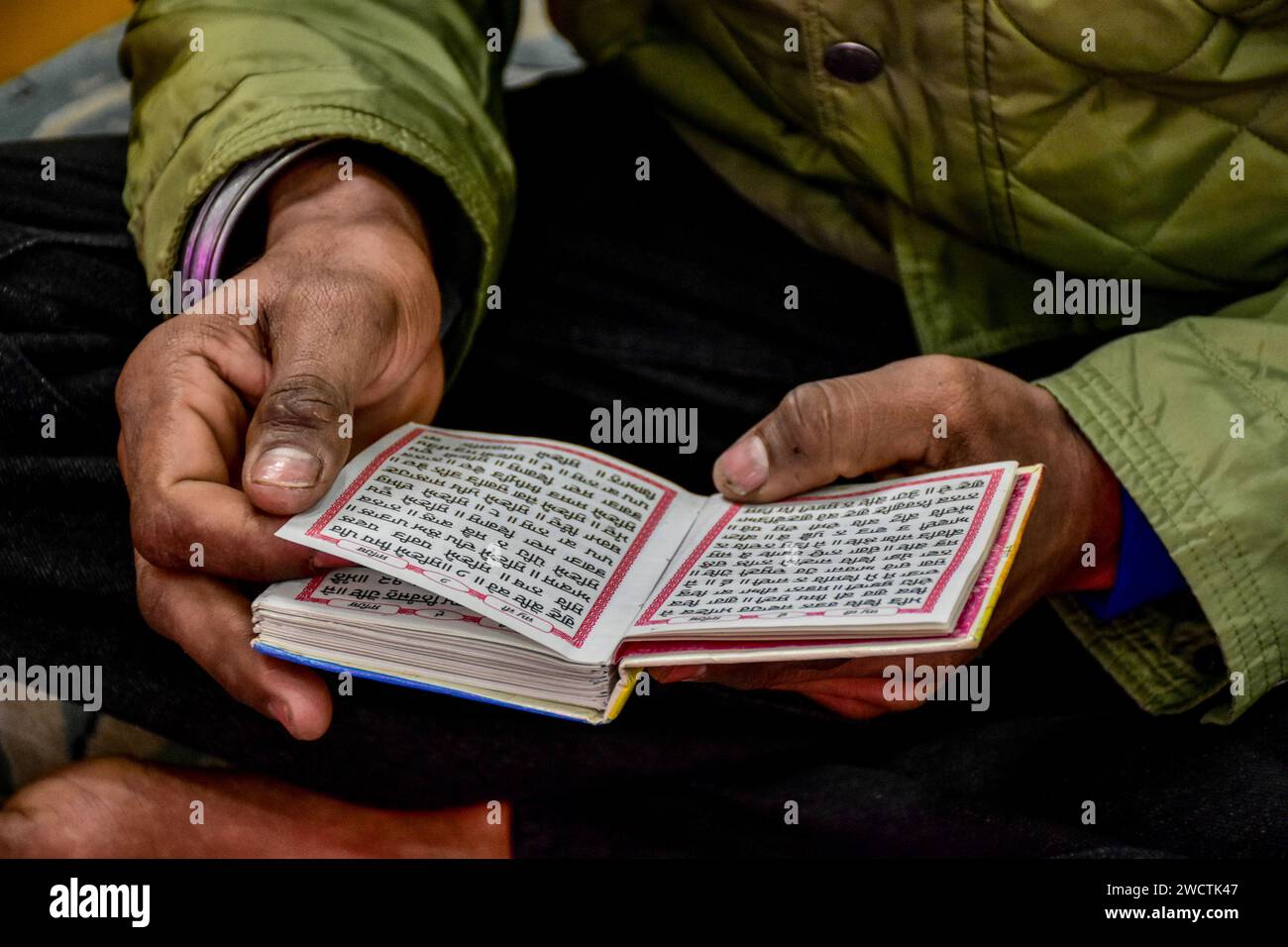 Srinagar, India. 17th Jan, 2024. A Sikh devotee reads verses from the holy book on the occasion ...
