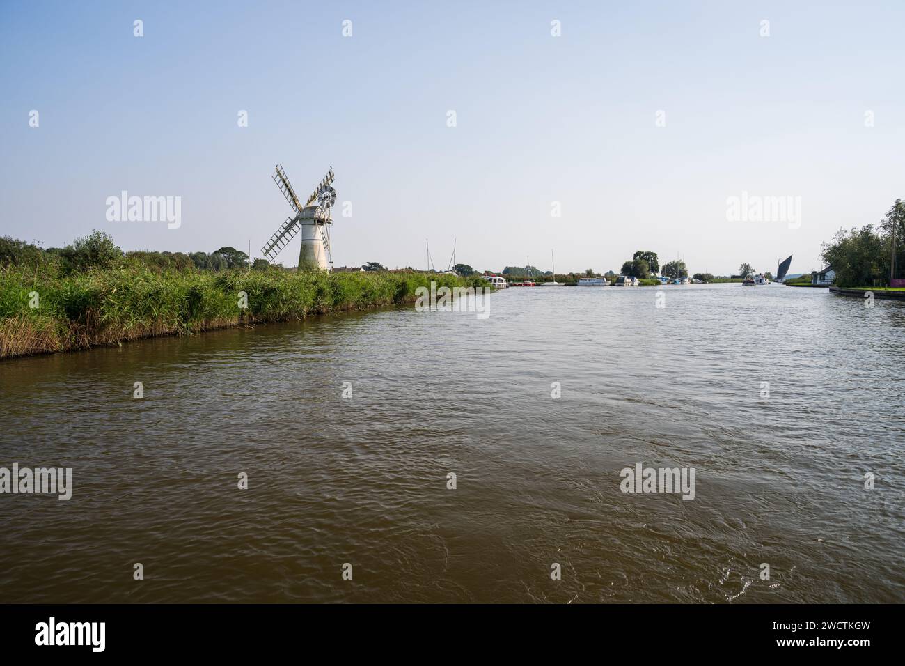 River Thurne and Thurne mill with a Norfolk Wherry sailing boat in the ...