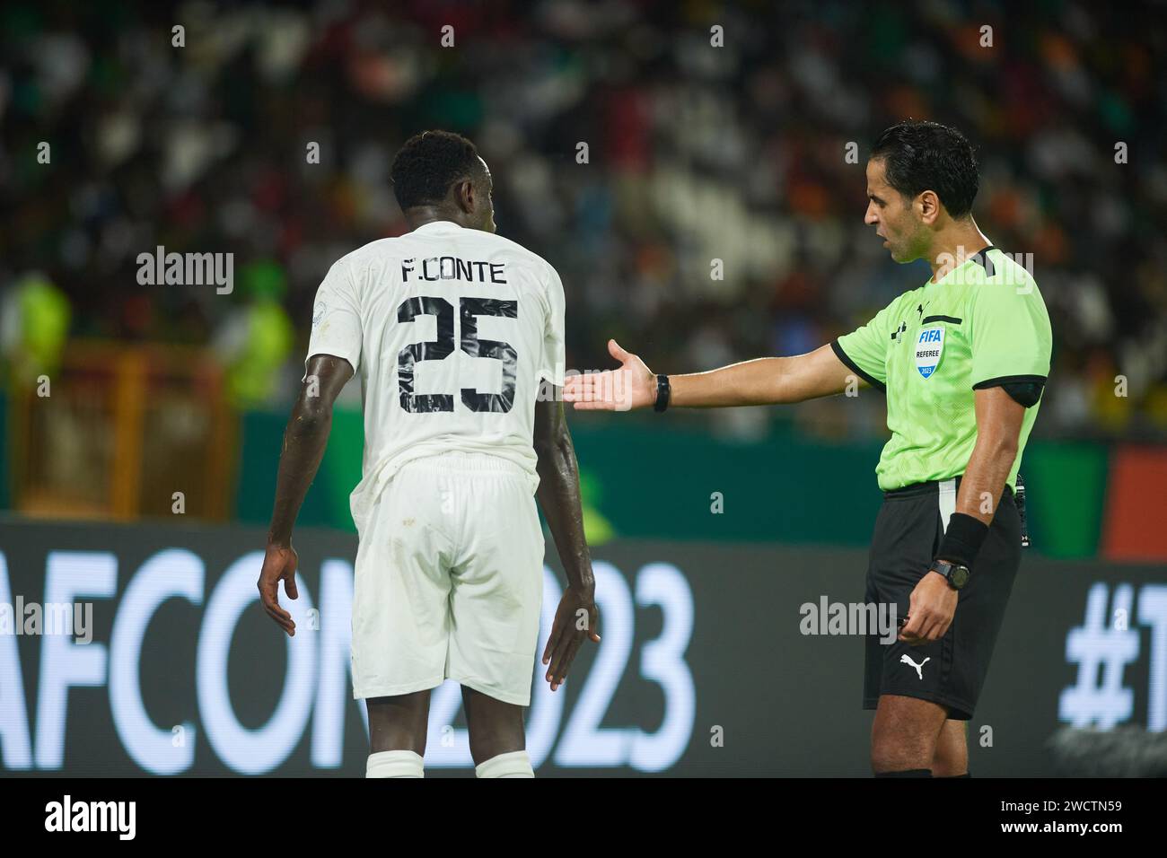 the referee Ibrahim Mutaz pointing out to Guinea's Facinet Conte Stock ...