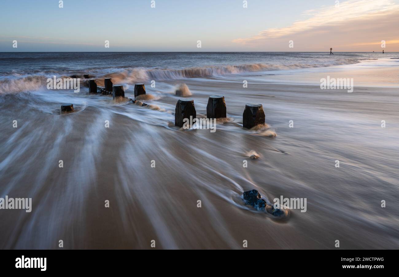 Soft sunrise swooshing seascape with old sea defences at Cart Gap ...