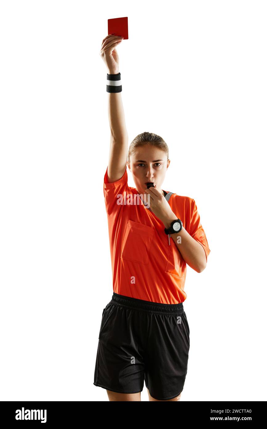 Young concentrated woman, soccer referee blowing a whistle and showing ...