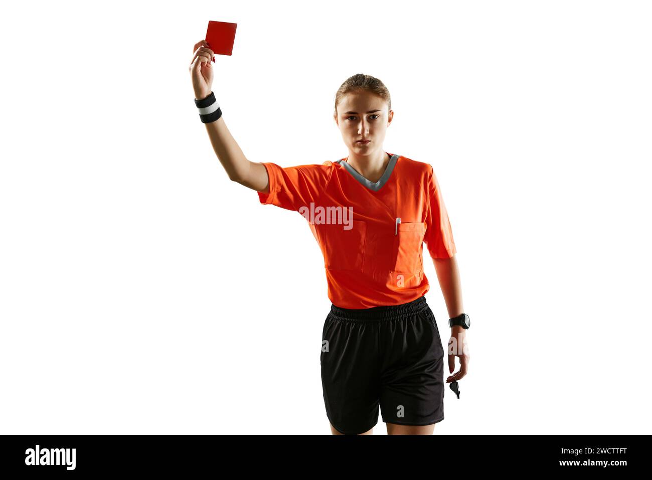 Serious young woman, football referee in uniform showing red card as ...