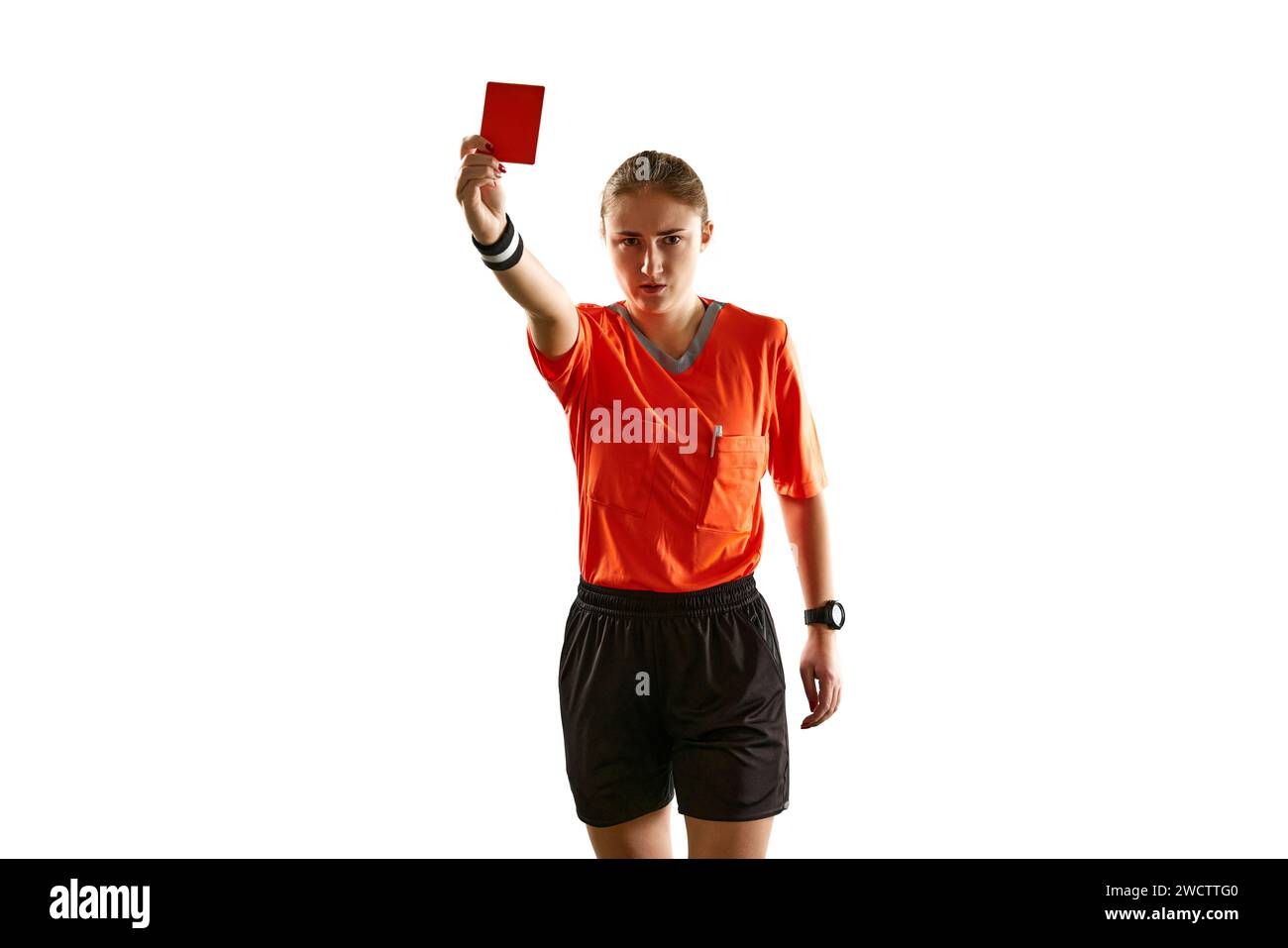 Serious young woman, football referee in uniform showing red card as ...