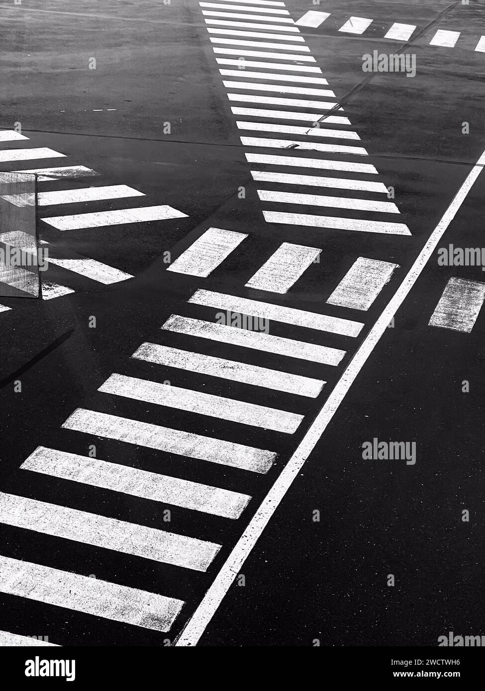 Black and white image of pedestrian crosswalk patterns on an empty ...