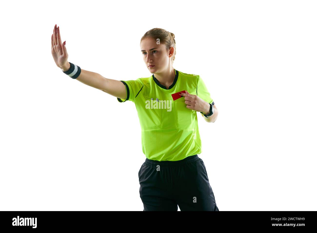 Serious woman, soccer referee gesturing, raising hand forward ...