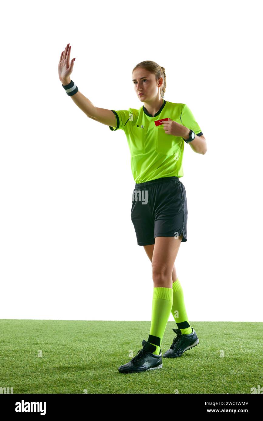 Serious woman, soccer referee gesturing, raising hand forward ...