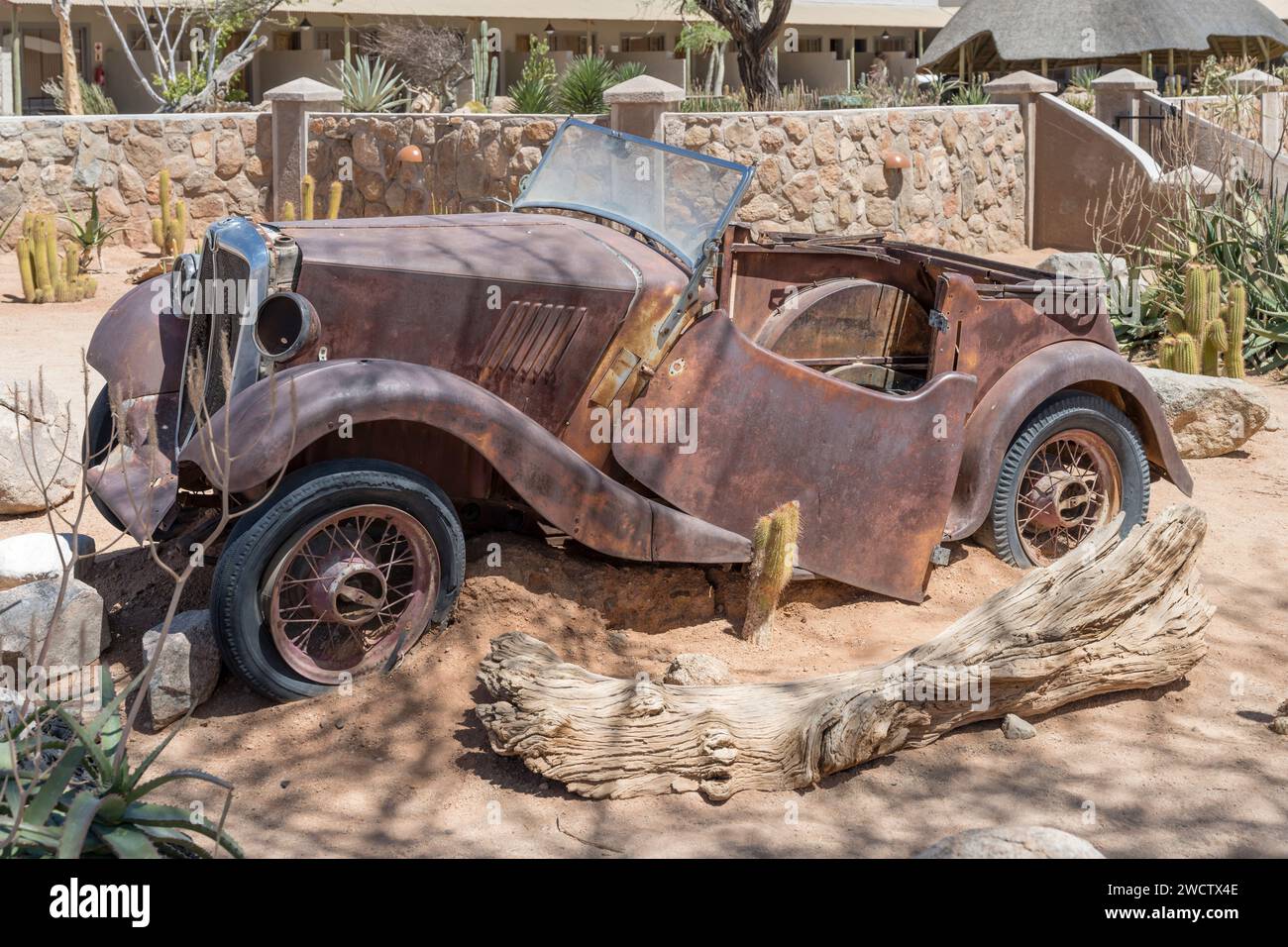 vintage car wreck worn down by rust in exibition at fuel station in ...