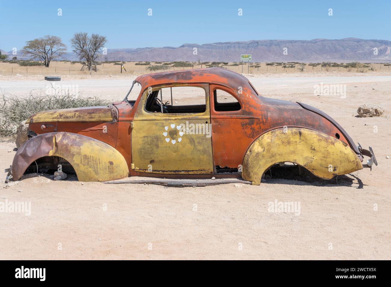 vintage 40's car-body wreck worn down by rust in exibition at fuel ...