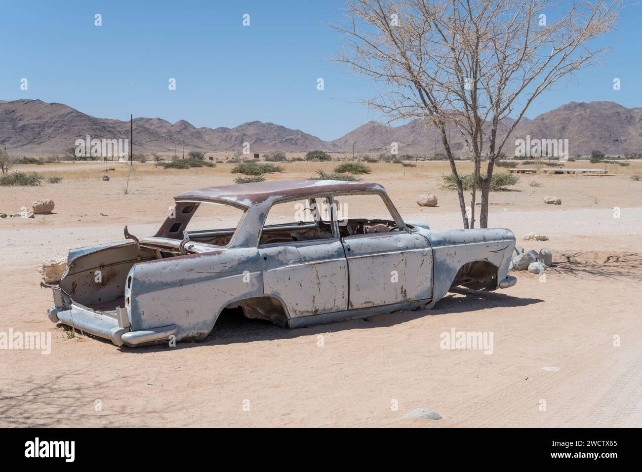 vintage 60's car-body wreck worn down by rust in exibition at fuel ...