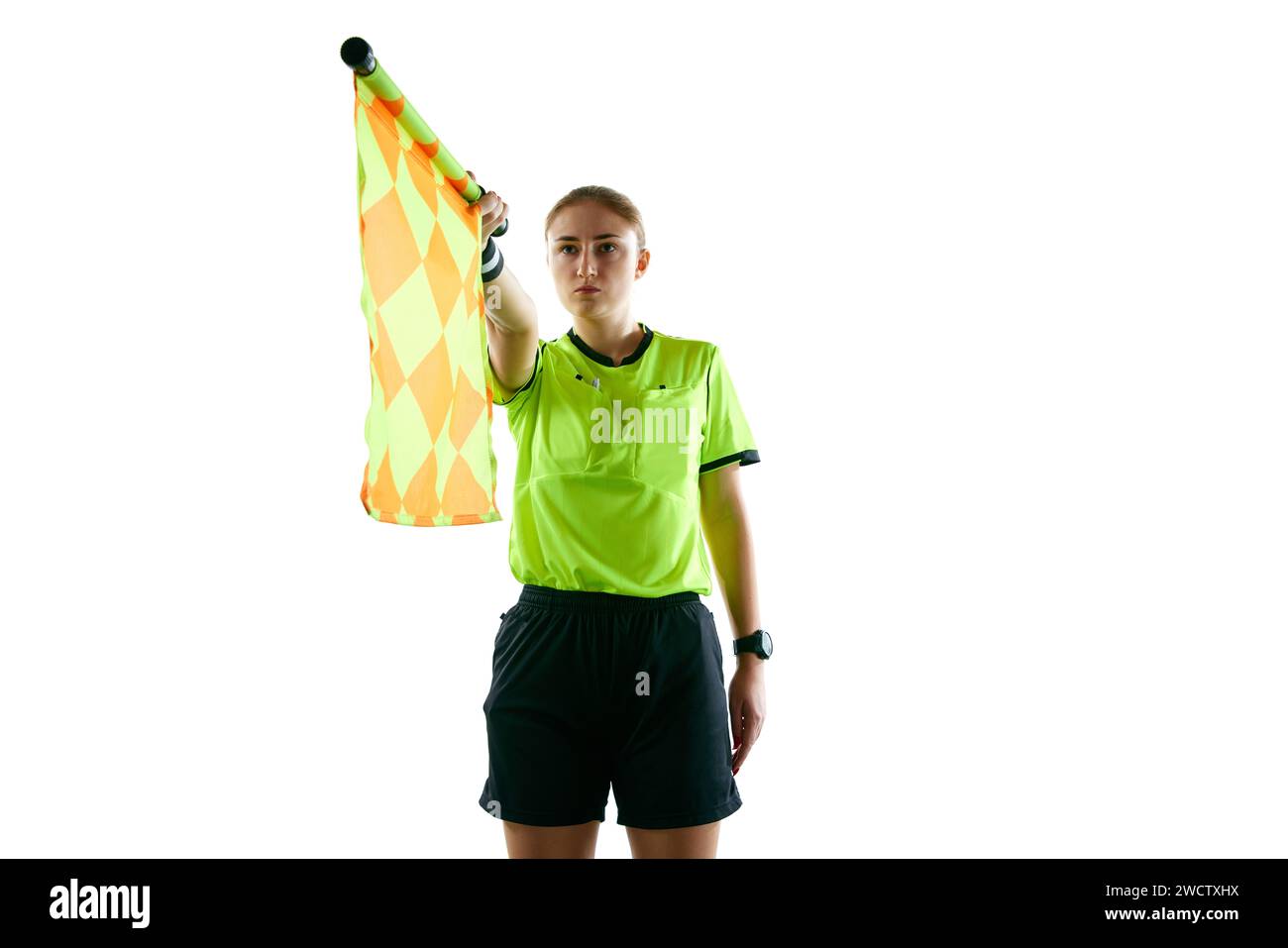 Assistant referee, serious woman in uniform standing on field and ...