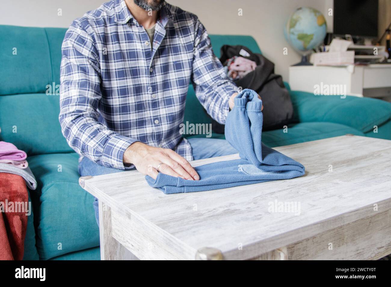 Folding clothes laundry male hi-res stock photography and images - Alamy