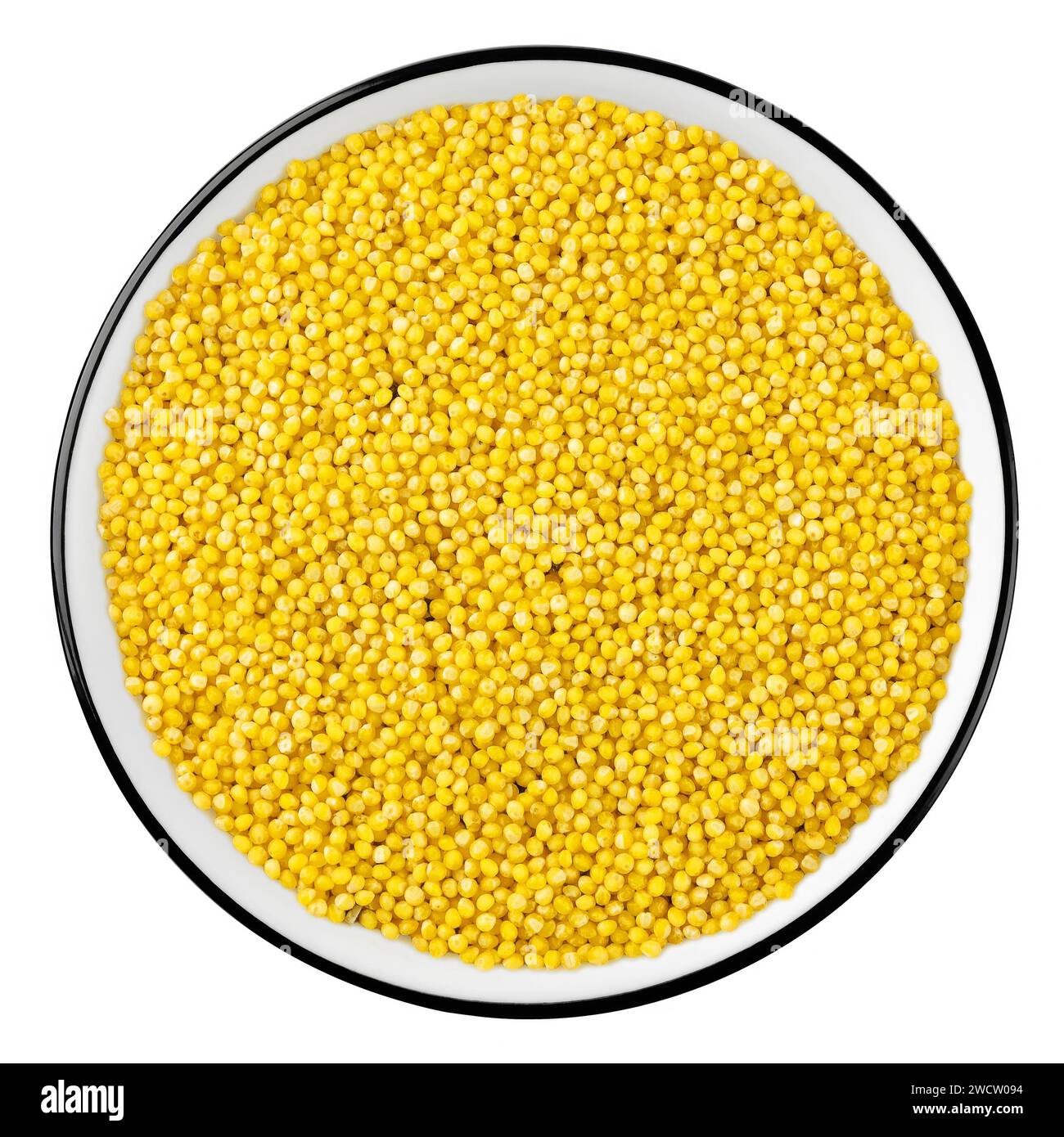 Top view of raw yellow millet grains in bowl isolated on white ...