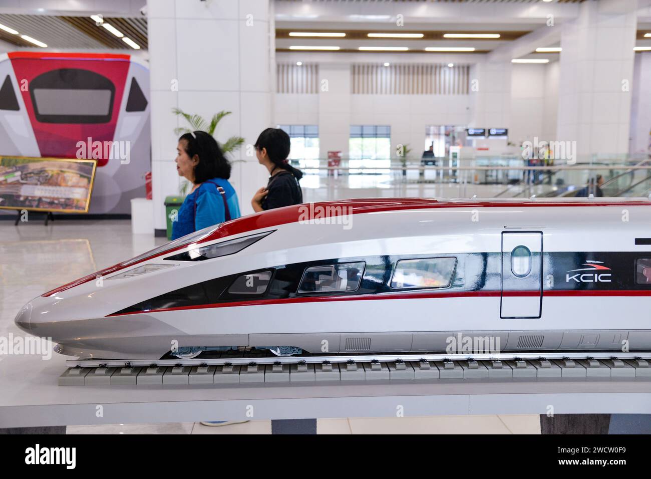 (240117) -- JAKARTA, Jan. 17, 2024 (Xinhua) -- Passengers walk past a model of a high-speed ...