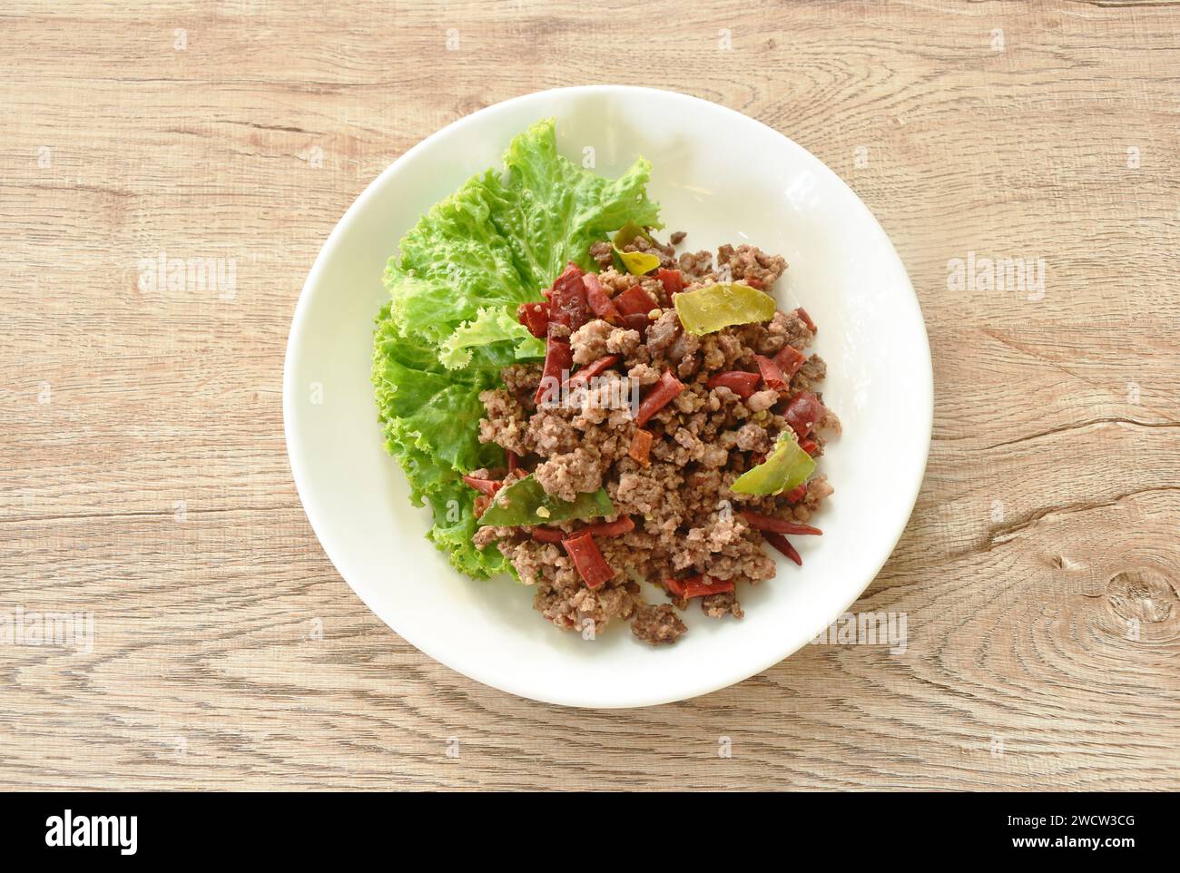 spicy fried chop beef meat couple dry chili with lettuce on plate Stock ...