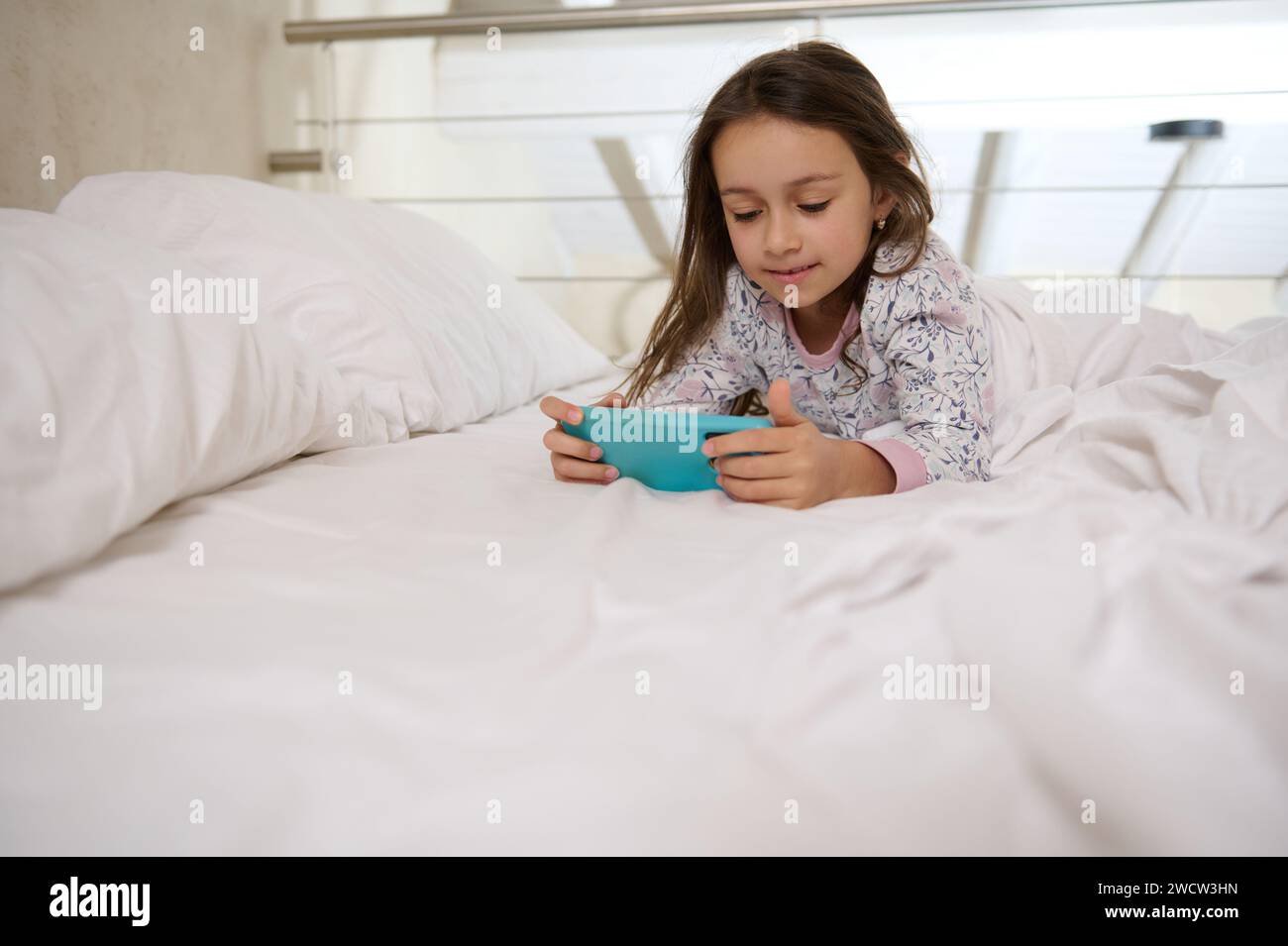 Adorable Caucasian lovey little child girl in nightwear, watching ... Adorable Caucasian lovey little child girl in nightwear, watching ...