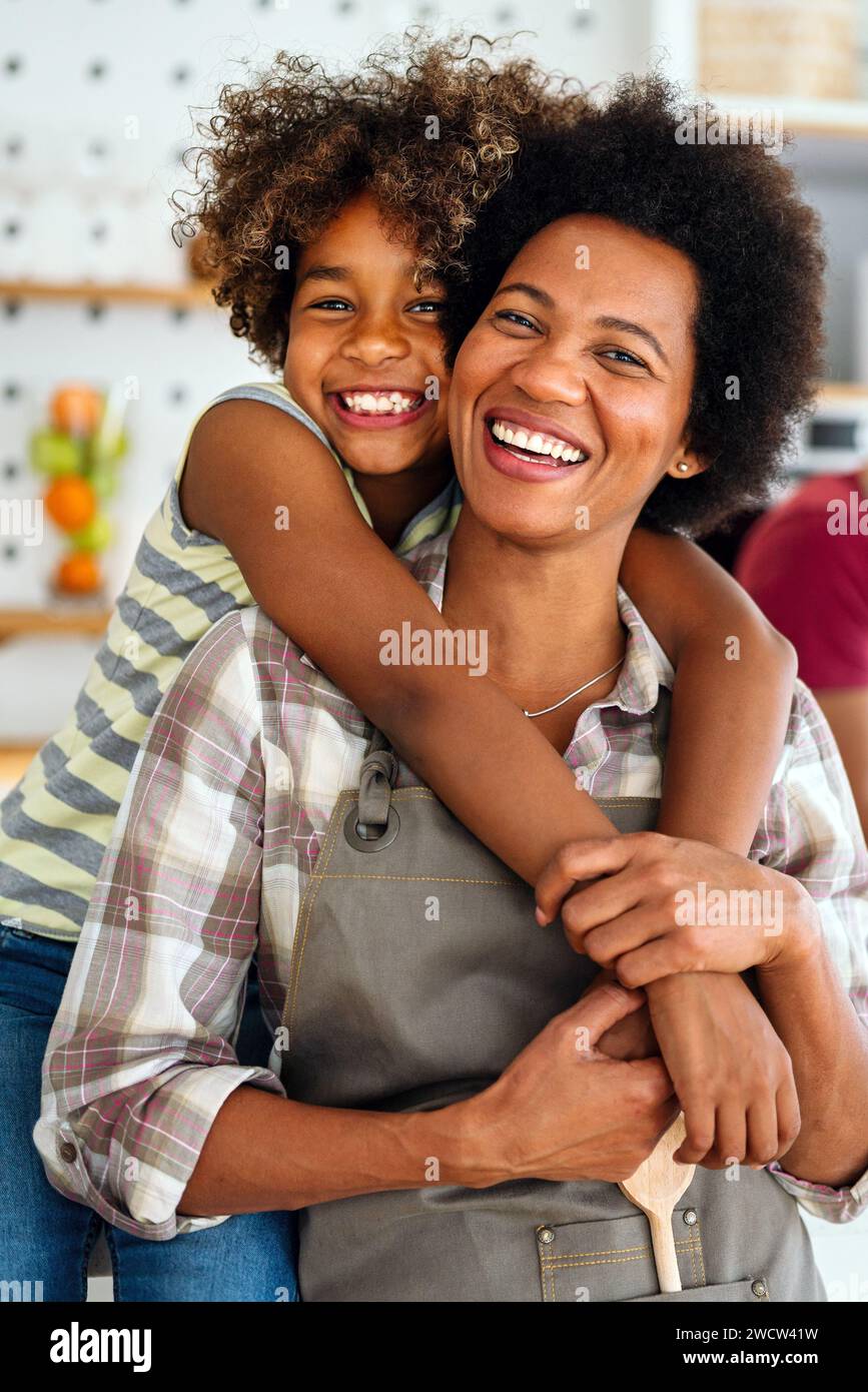 African american woman hugging her smiling teen daughter. Family love single parent child ...