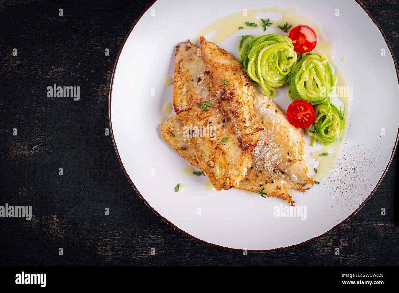 Grilled fish fillet with zucchini pasta. Healthy food concept. Top view ...