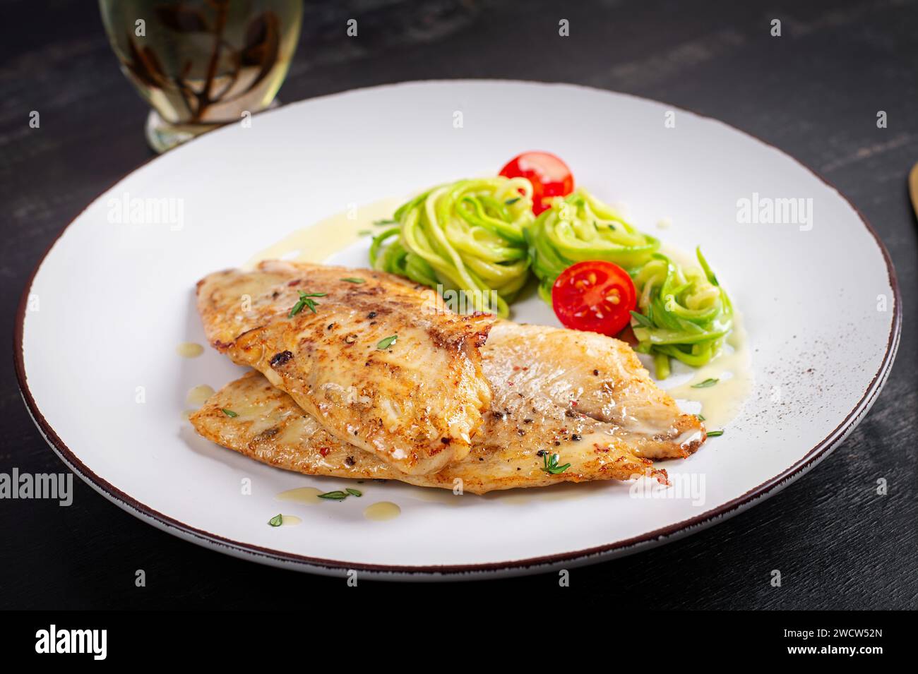 Grilled fish fillet with zucchini pasta. Healthy food concept Stock ...