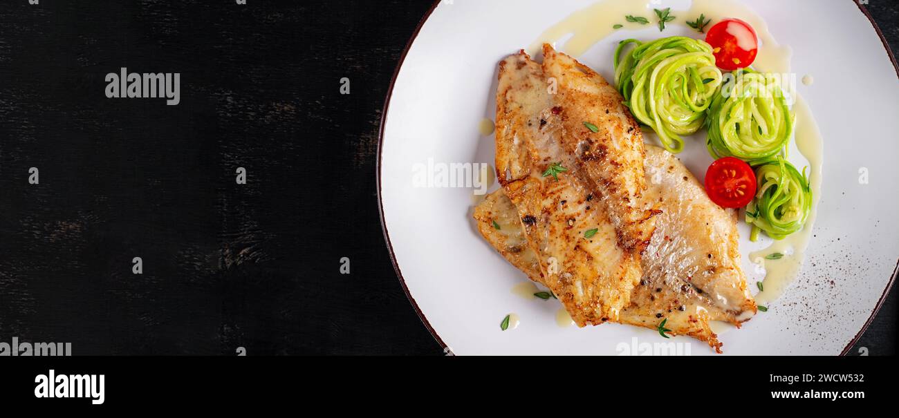 Grilled fish fillet with zucchini pasta. Healthy food concept. Top view ...