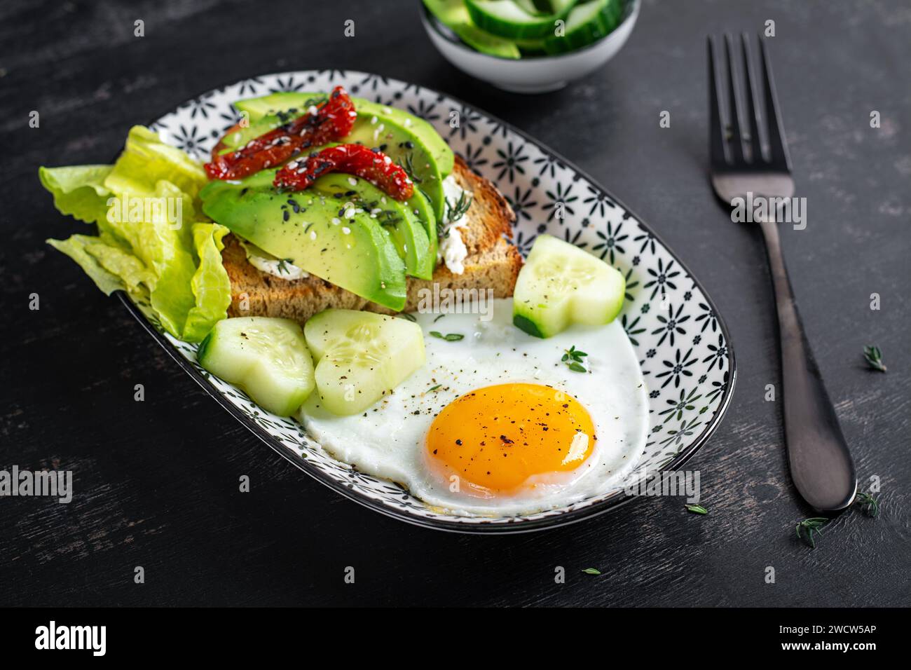 Romantic breakfast for Valentine's Day. Fried egg and toast with avocado and cream cheese Stock ...