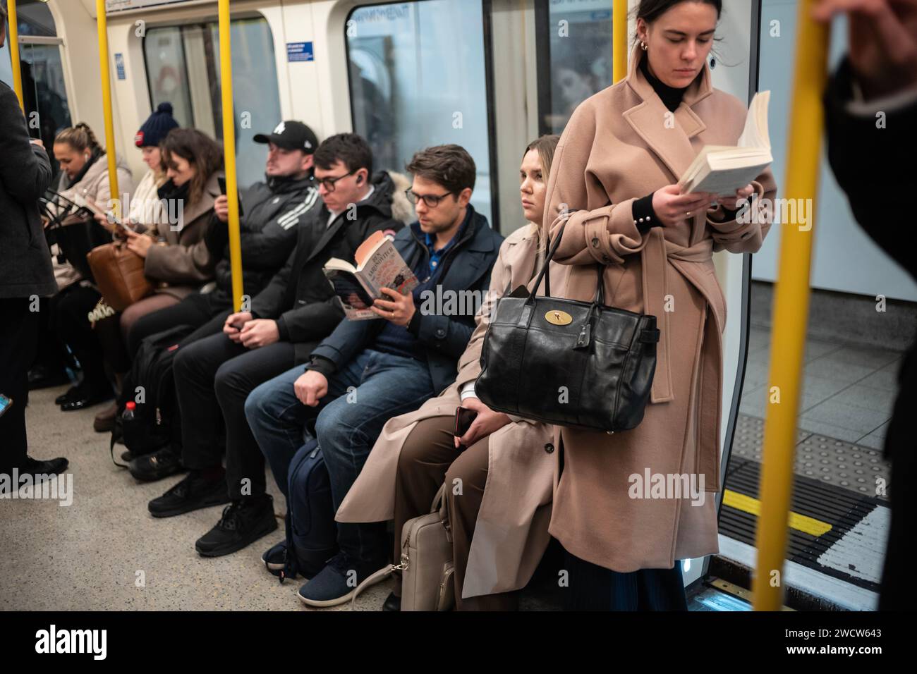 Woman holding handbag london underground hi-res stock photography and ...
