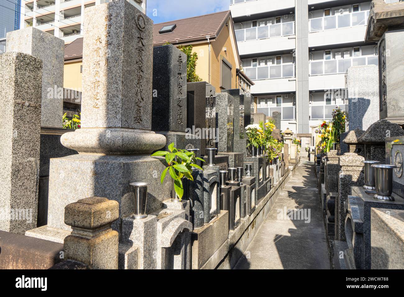 Tokyo, Japan. January 2024. Interior view of graves in a small cemetery ...