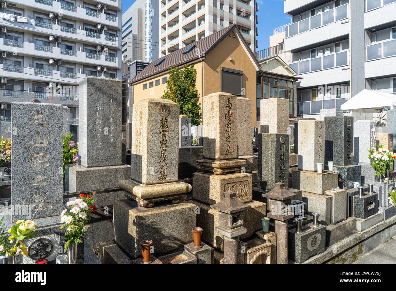Tokyo, Japan. January 2024. Interior view of graves in a small cemetery ...
