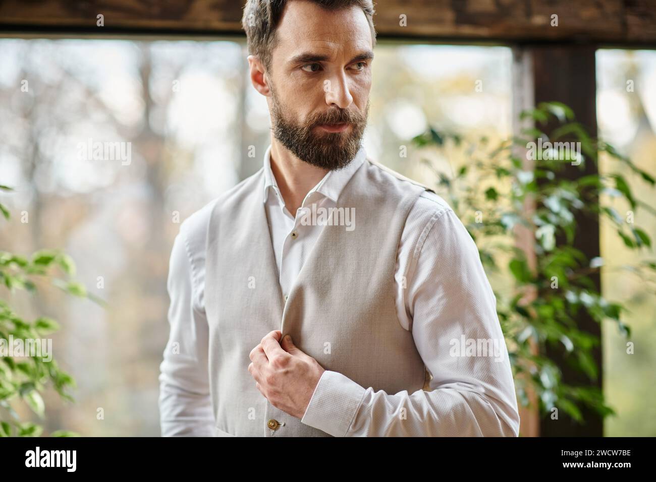 attractive concentrated leader with beard in sophisticated attire ...