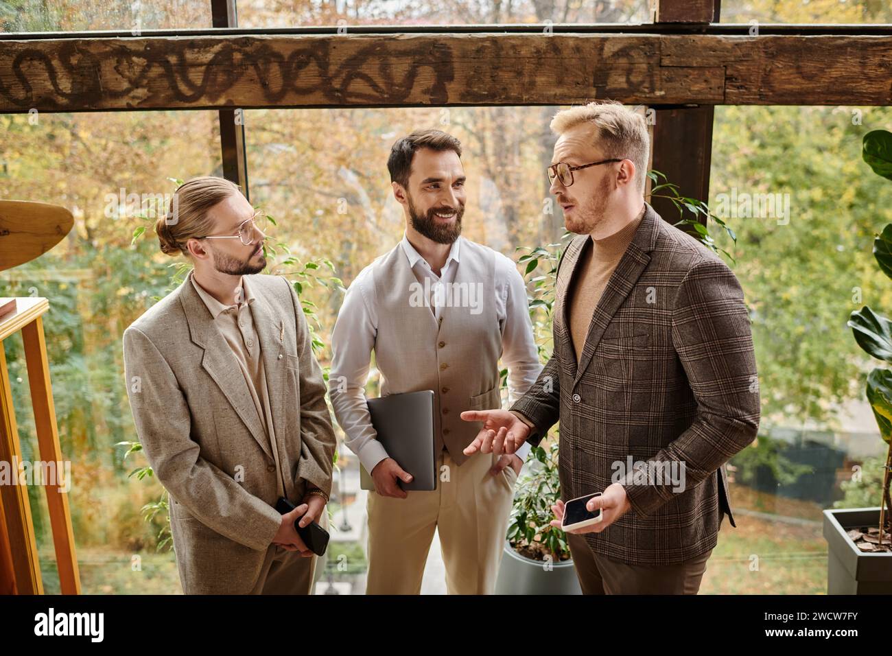 cheerful good looking businessmen in elegant outfits discussing their ...