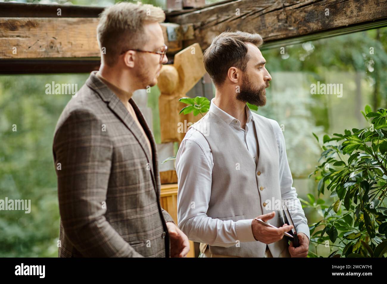 concentrated elegant business leaders in sophisticated clothes posing ...