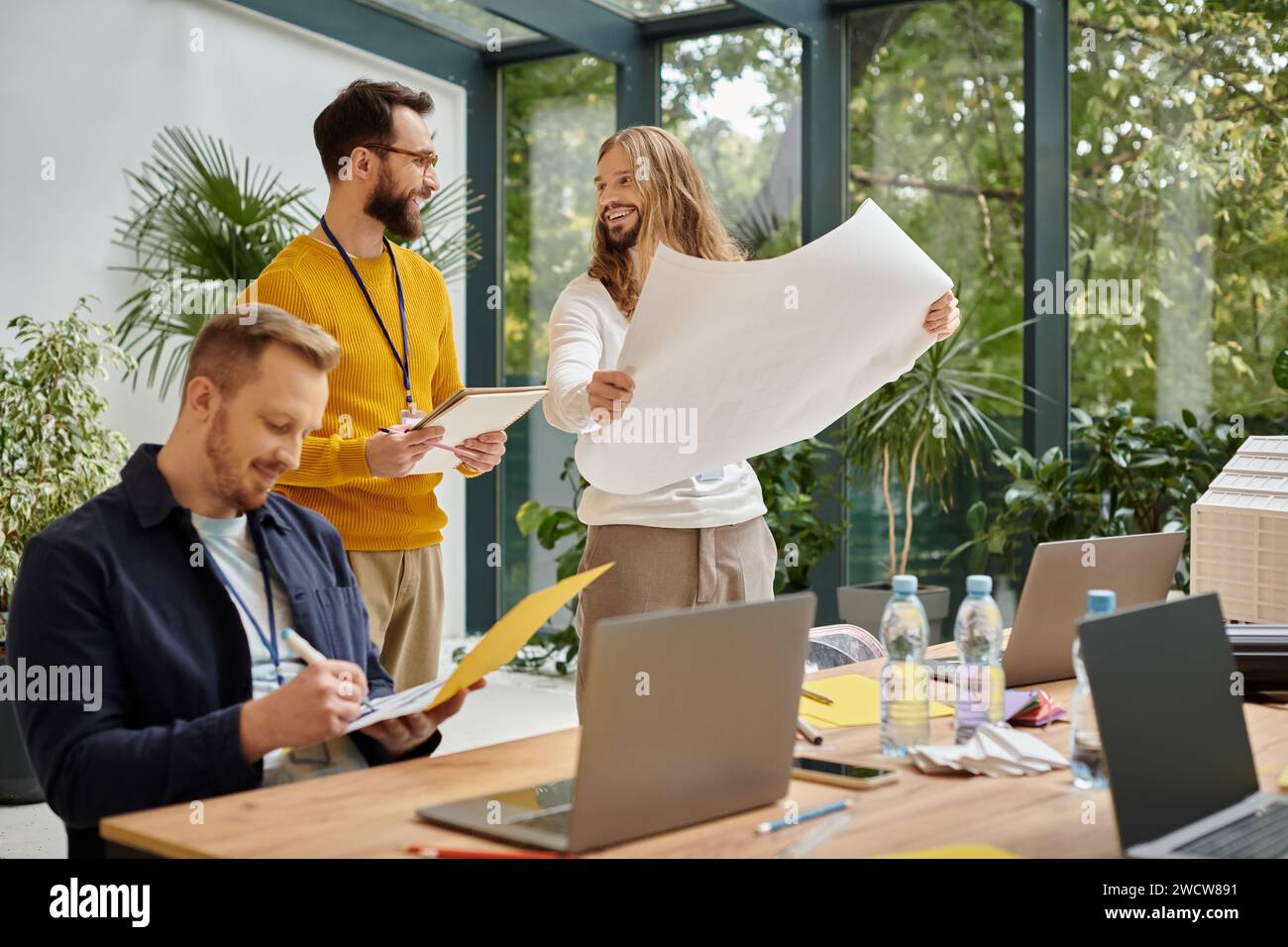 joyous appealing businessmen in casual outfit working attentively on ...
