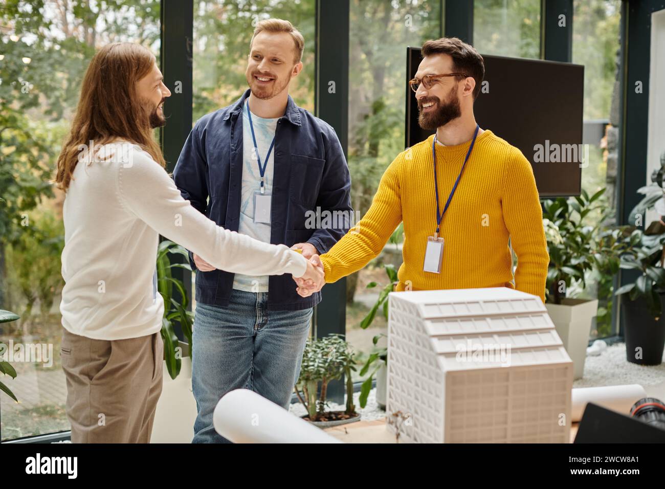 cheerful handsome architects in casual outfits working together on ...
