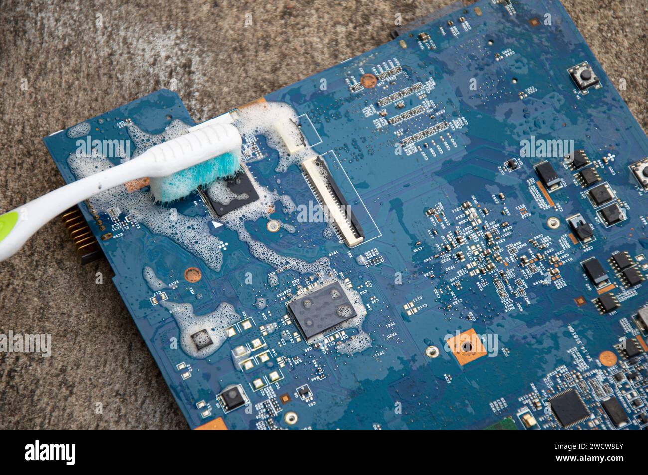 Top view. Technician cleaning motherboard. computer with cleaning ...