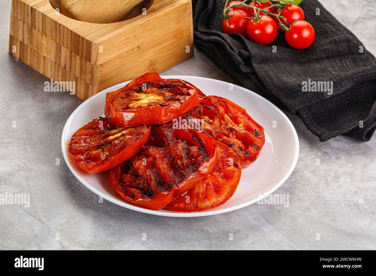 Vegan cuisine - Griiled ripe red tomatoes snack Stock Photo - Alamy
