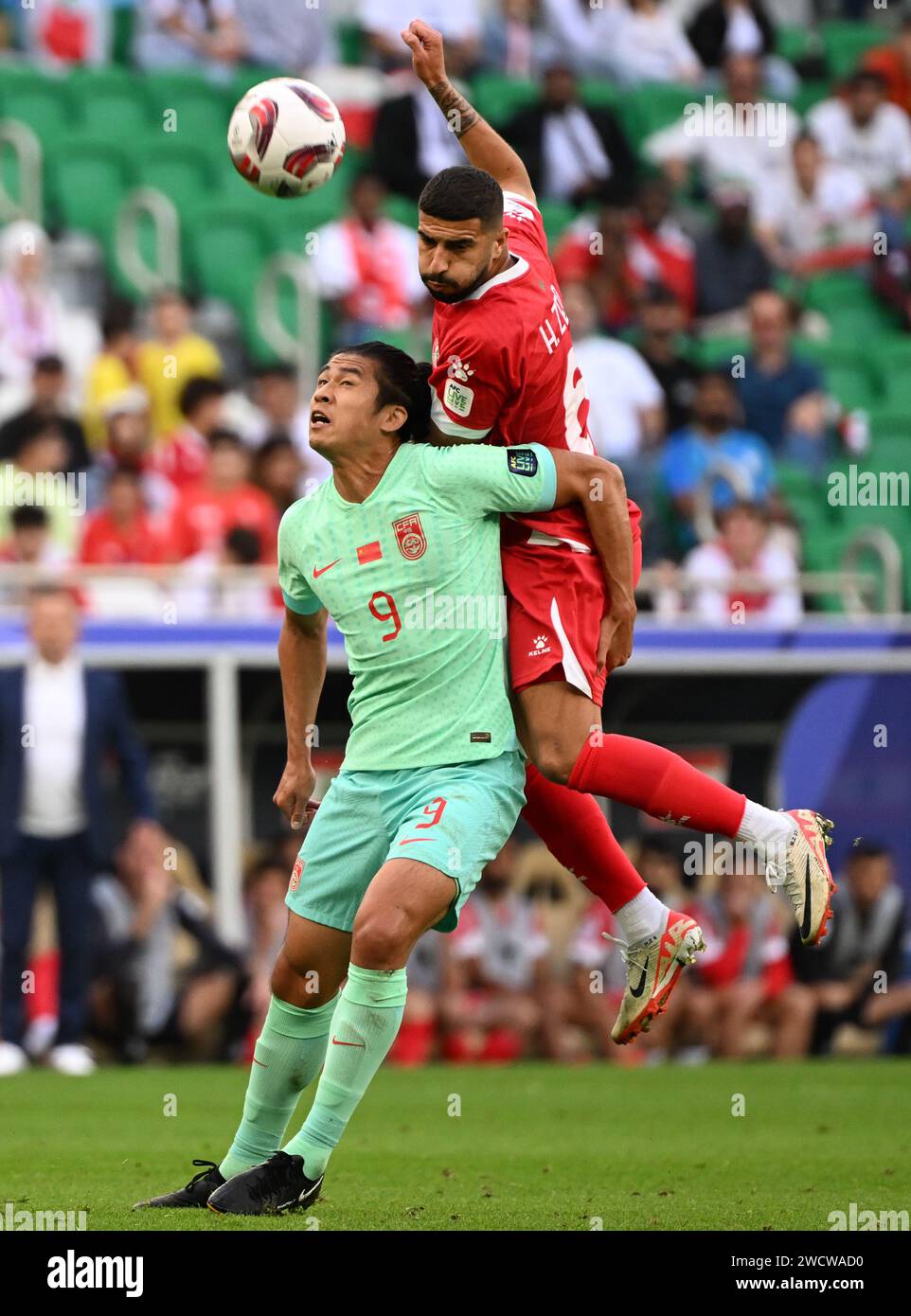 Doha, Qatar. 17th Jan, 2024. Zhang Yuning (L) of China vies with ...