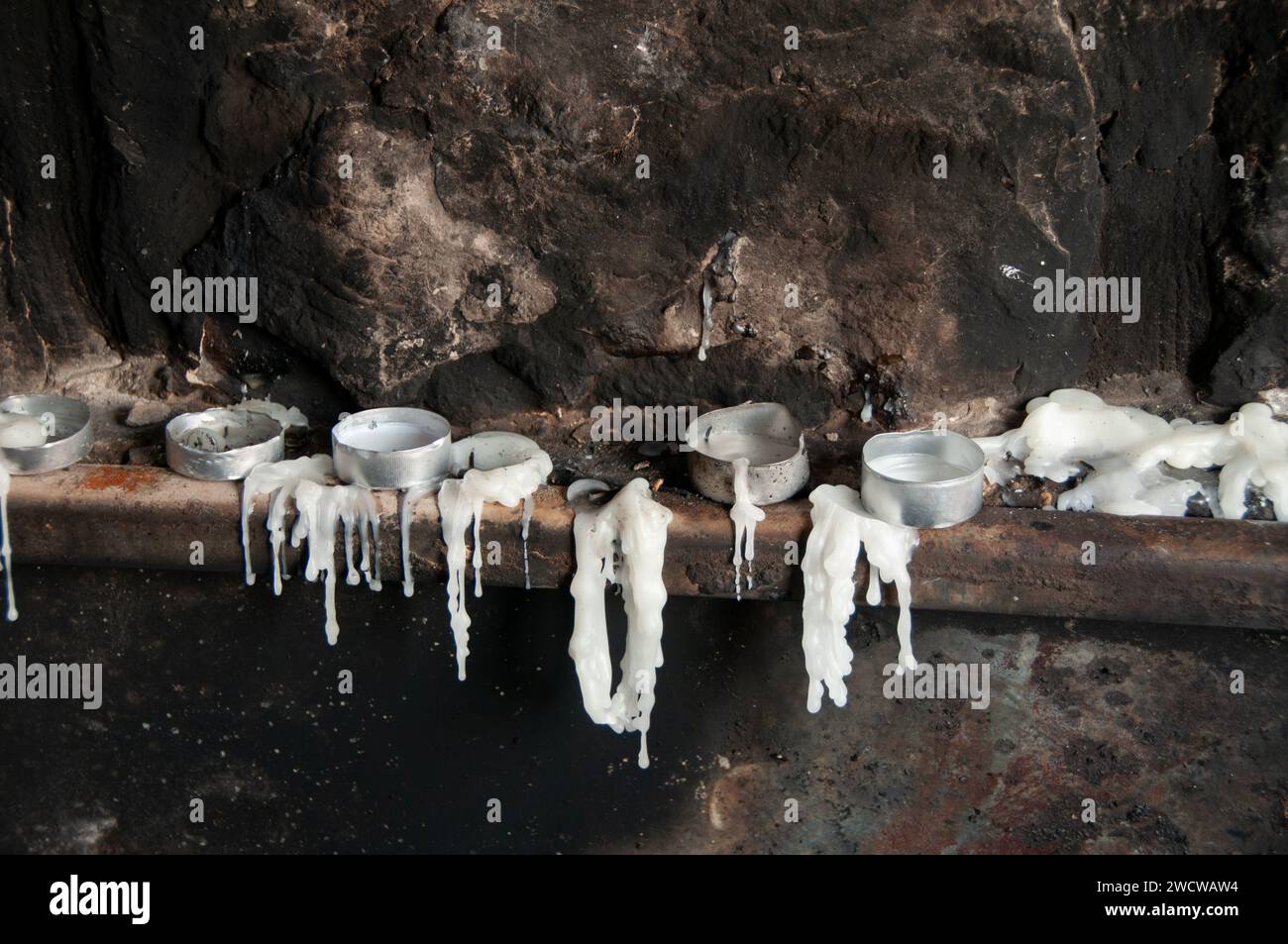 Unlit, consumed and burnt tea candles and wax drippings outside the ...