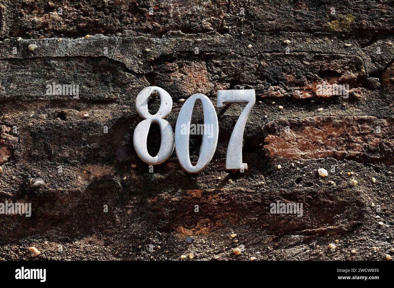 Street sign number 807 on a stone wall Stock Photo - Alamy