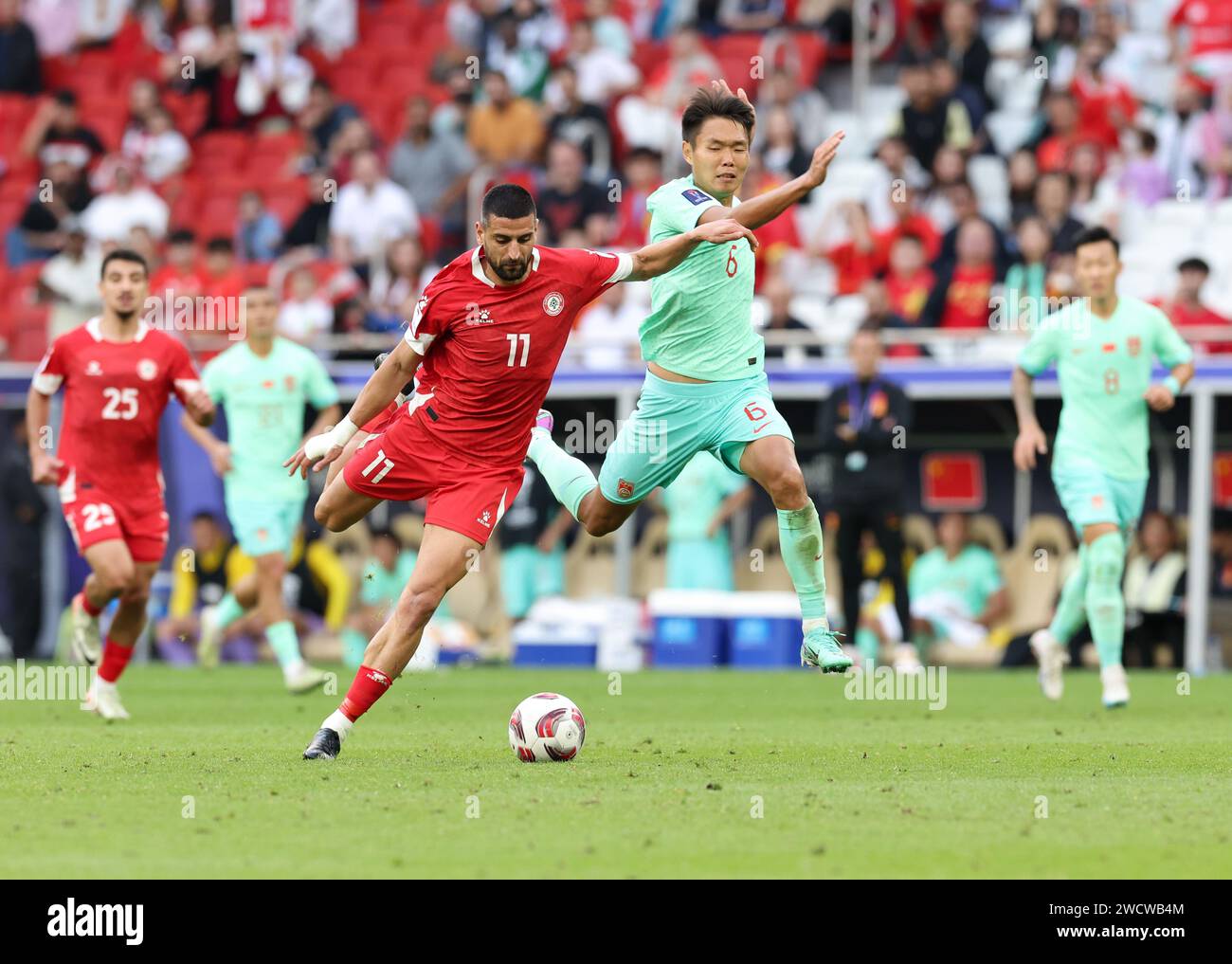 Doha, Qatar. 17th Jan, 2024. Wang Shangyuan (R) of China vies with Omar ...