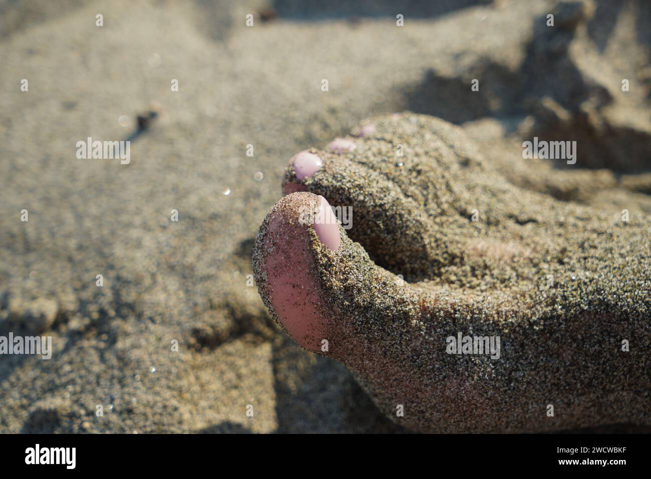 foot covered in sand on the beach Stock Photo - Alamy