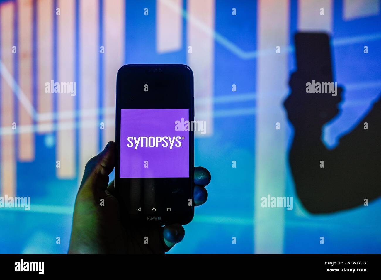 In this photo illustration, a Synopsys logo is displayed on a ...