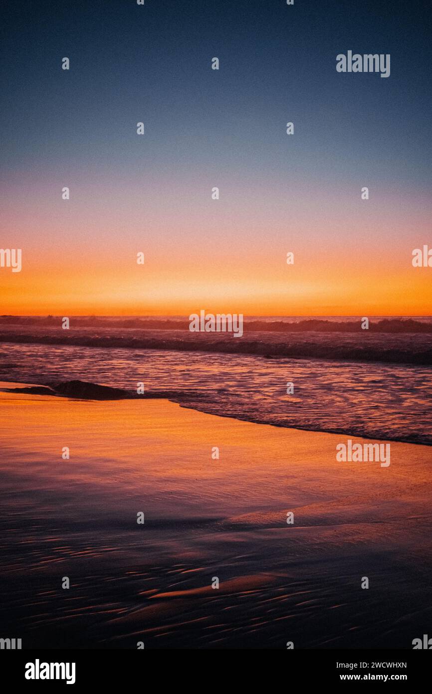 A sunset on a beach with beautiful golden hour colours Stock Photo - Alamy