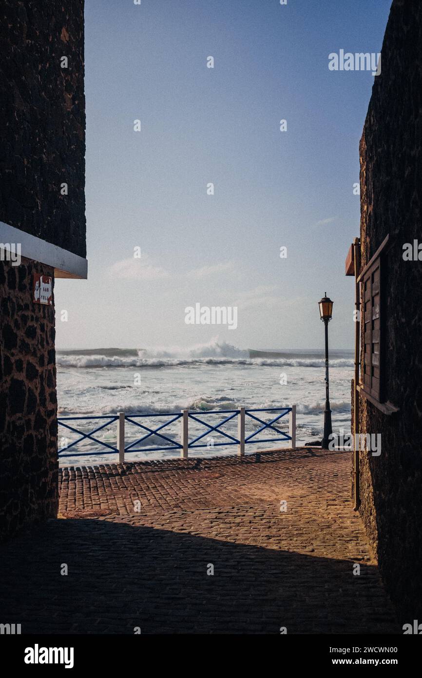 A view of the ocean from a small street in a fishing village Stock ...