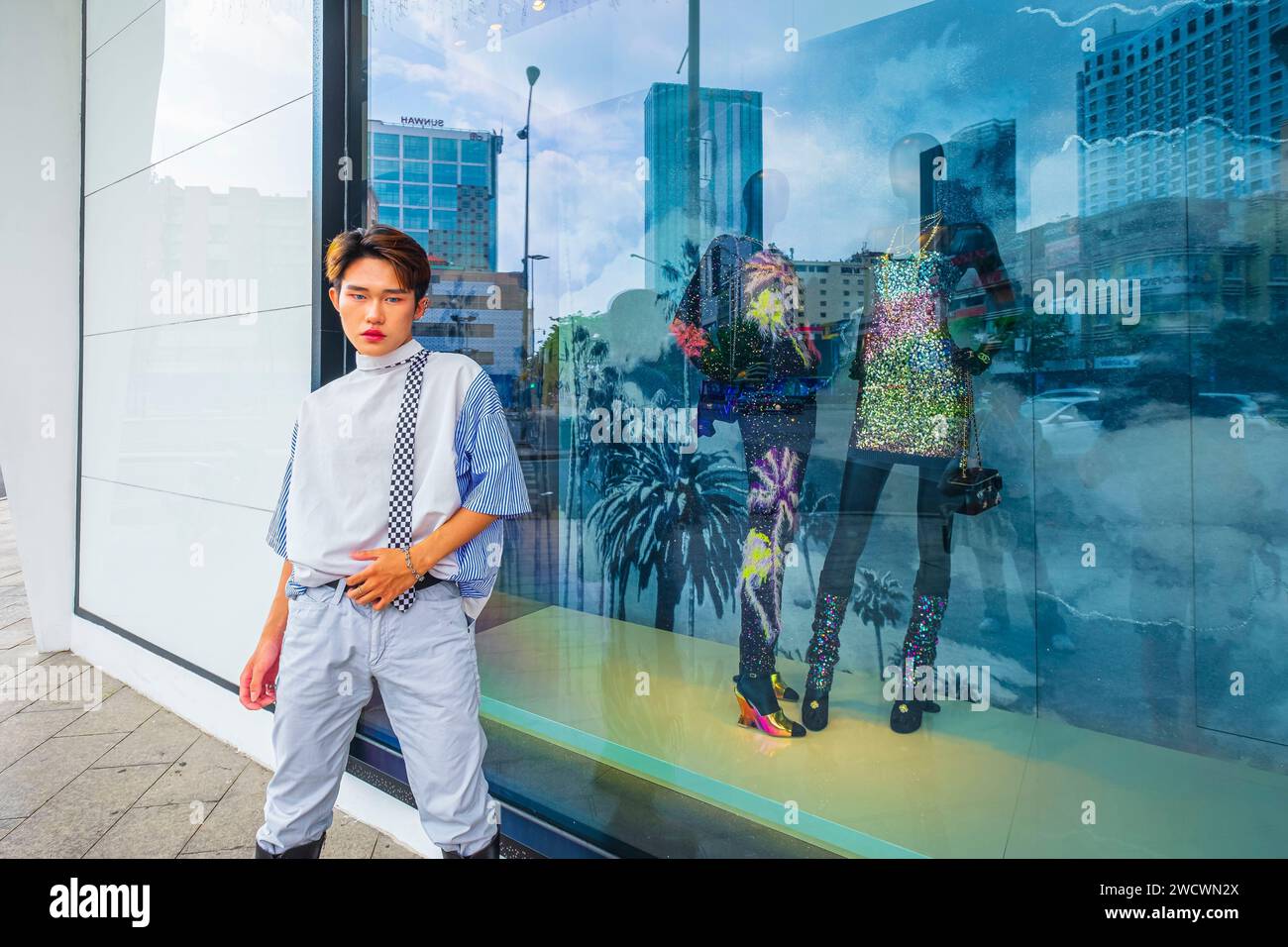 Vietnam, Ho Chi Minh City (Saigon), District 1, model posing in front ...