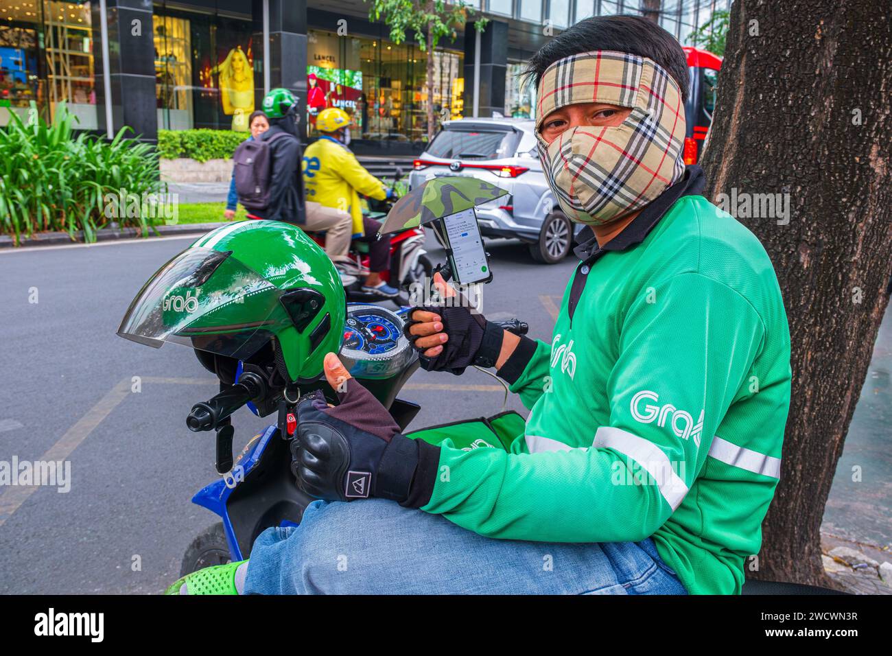 Vietnam, Ho Chi Minh City (Saigon), District 1, motorcycle taxi driver ...