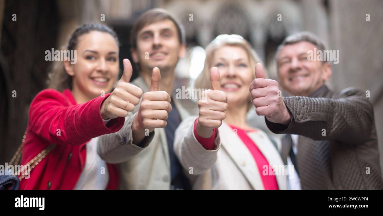 Tourists of different generations thumb up and smiling Stock Photo - Alamy
