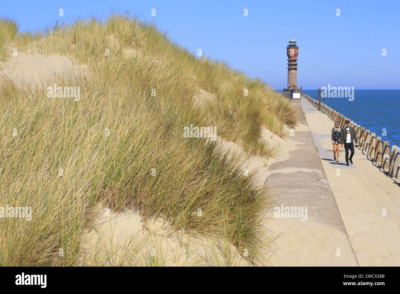 France, Nord, Dunkirk, west pier of the port, dunes and the fire of ...