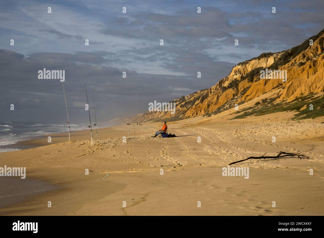 Portugal, Alentejo, Gale Fontainhas beach, fisherman sitting on the ...