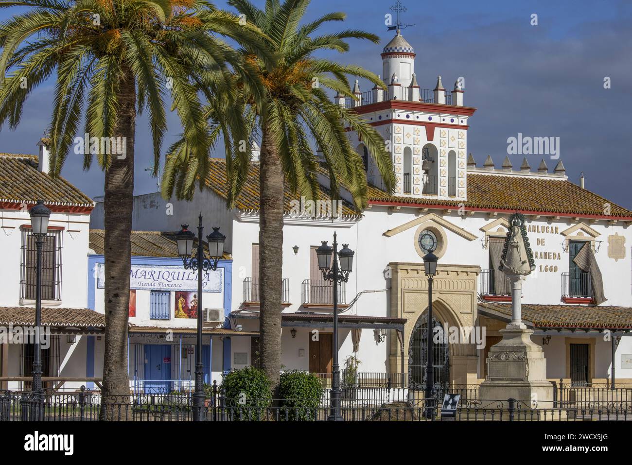 Spain, Andalusia, El Rocío, square with palm trees in front of a ...