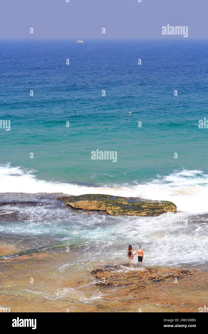 Couple sunbathing at the beach hi-res stock photography and images - Alamy